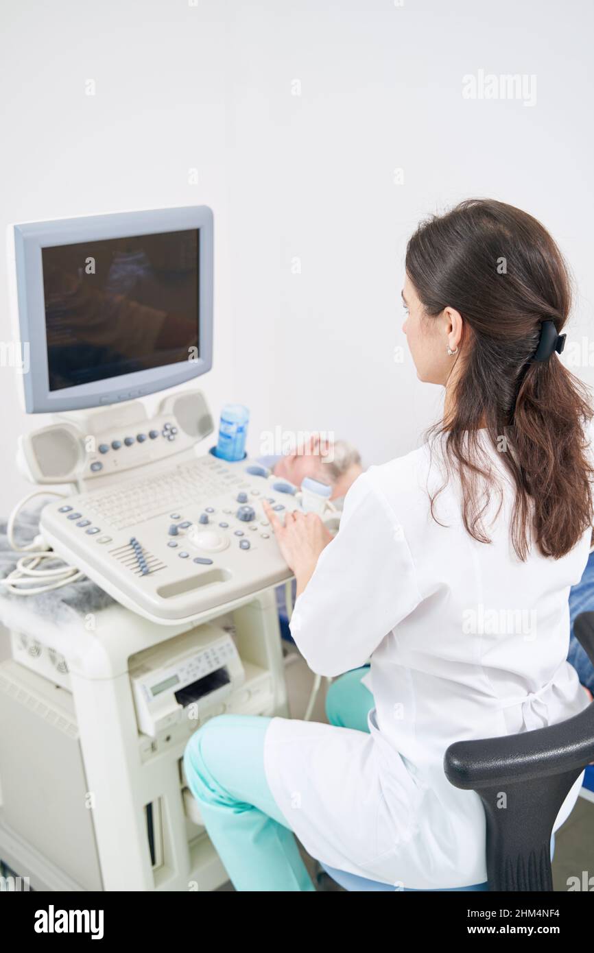 Female diagnostician examining patient using ultrasonic equipment Stock ...