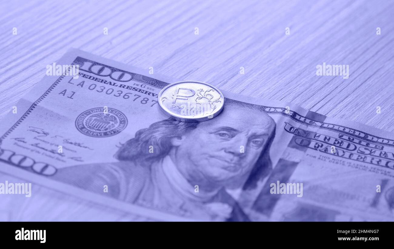 Russian one ruble coin on one hundred dollar bill. Currency rate ...
