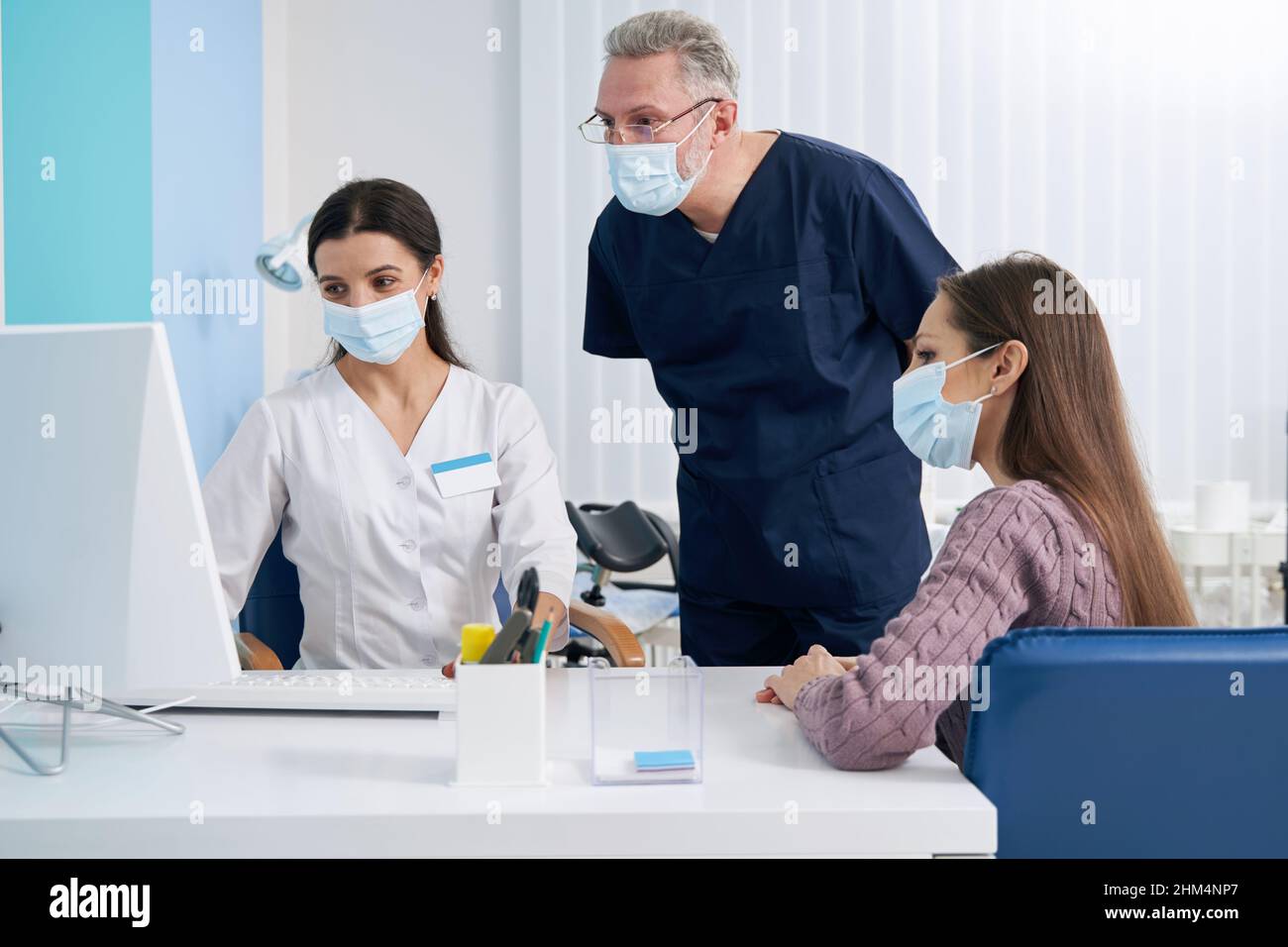 Two physicians staring at monitor screen during medical consultation ...