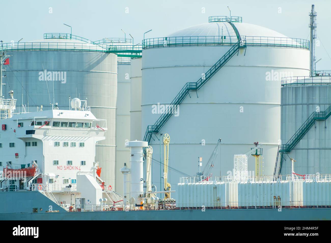 Oil tanker with a background of oil warehouse storage tanks in ...
