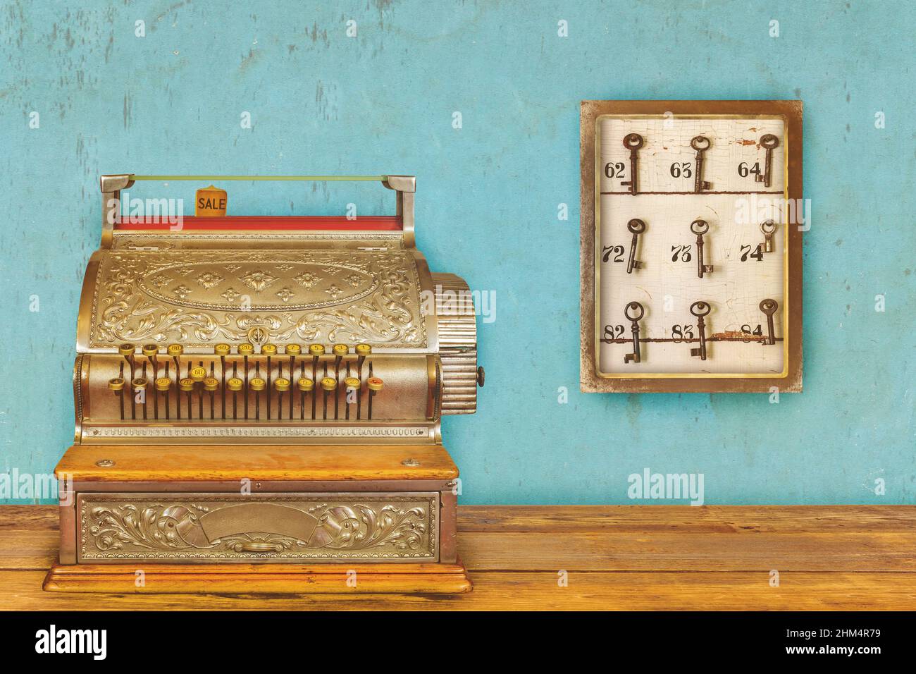 Cash register and cabinet with hotel keys and room numbers on a blue ...