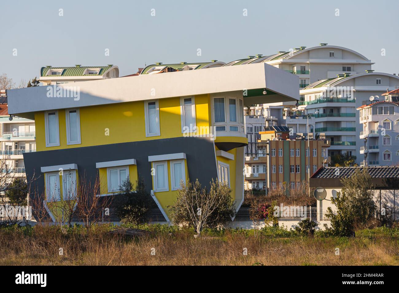 Unusual architecture. Gray-yellow stone upside-down house. Children's ...
