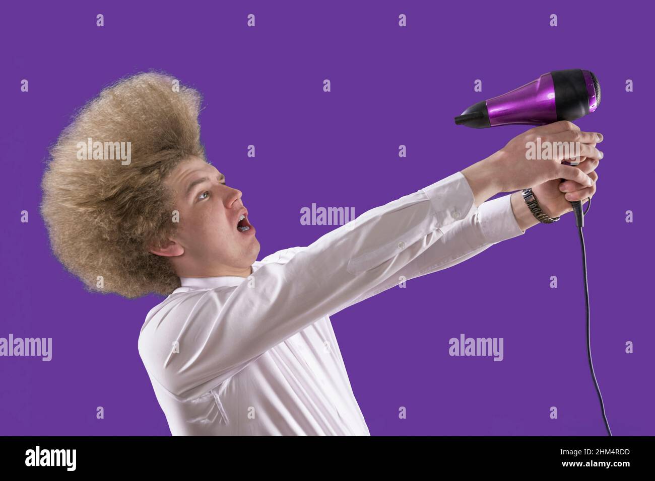 To dry hair. Beautiful hairstyle. Funny student. Shaggy guy. Direct air ...