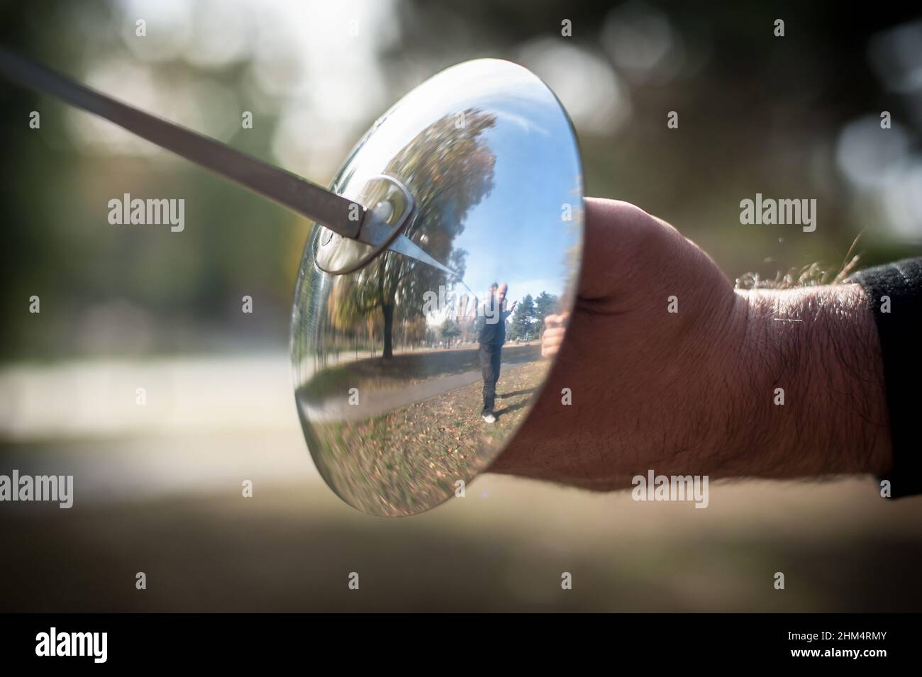 Fencing swordsman instructor demonstrates sword fighting techniques and ...