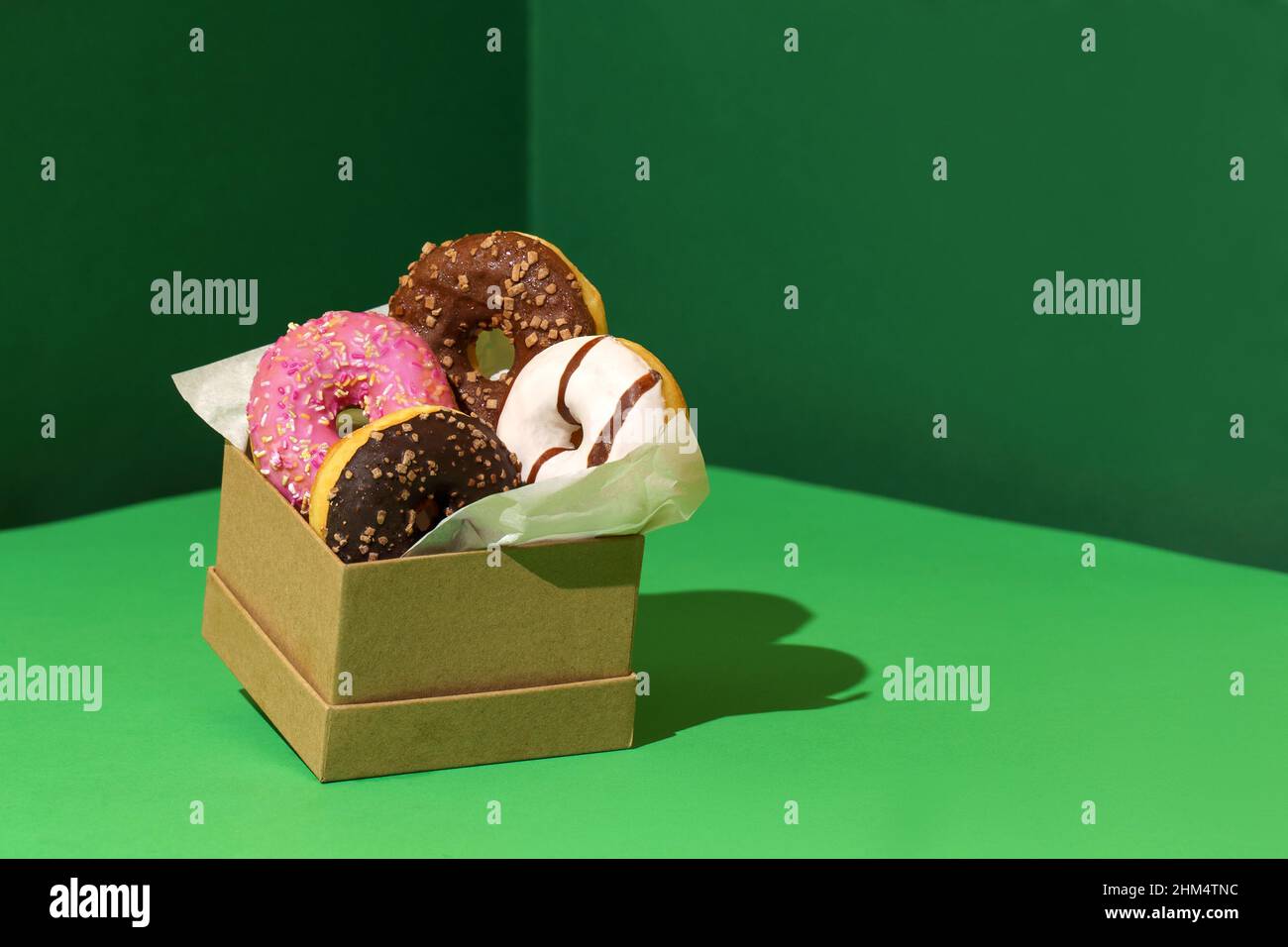 Donuts in craft box pink, chocolate, and white on green conner paper ...
