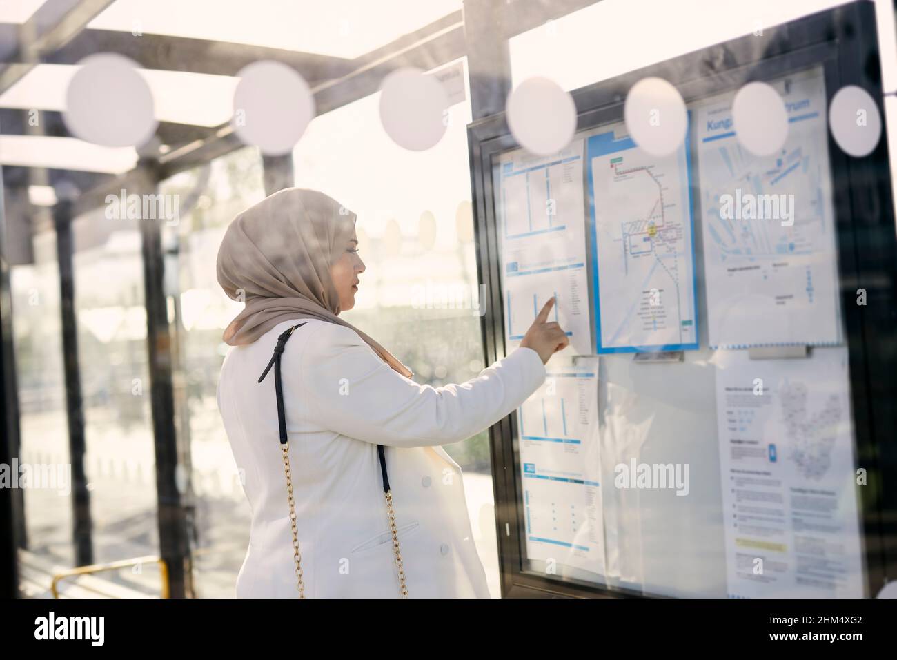 Checking bus timetable hi-res stock photography and images - Alamy