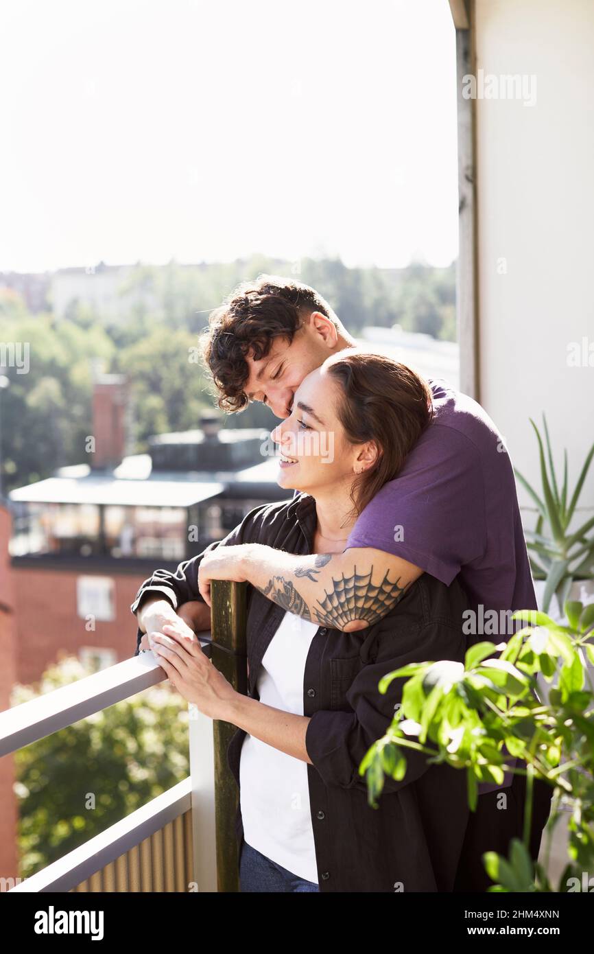 Couple standing on balcony Stock Photo - Alamy