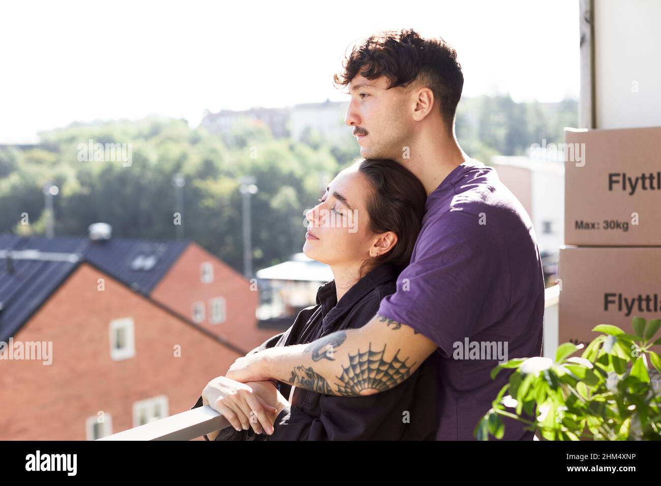 Couple standing on balcony Stock Photo - Alamy