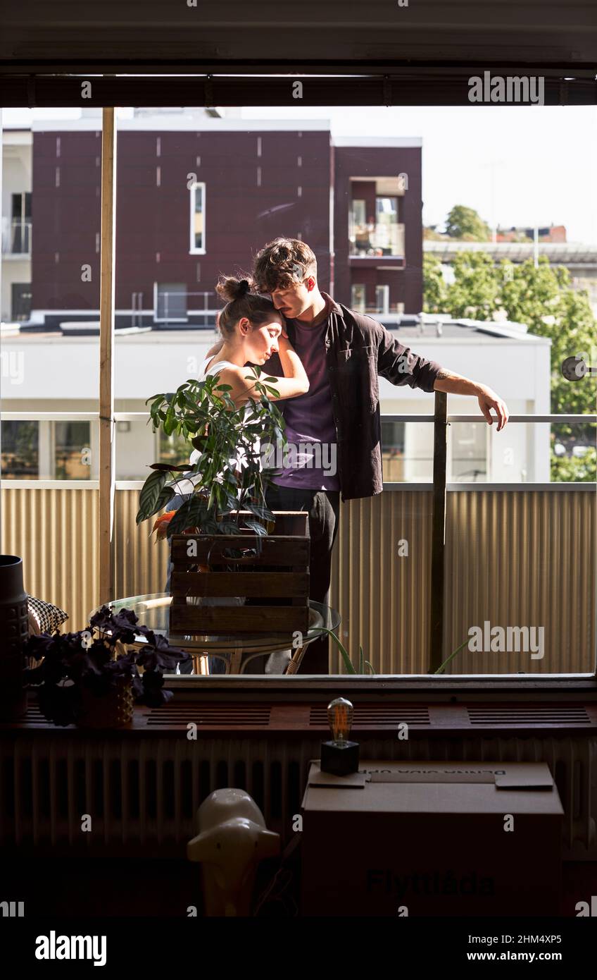 Couple standing on balcony Stock Photo - Alamy
