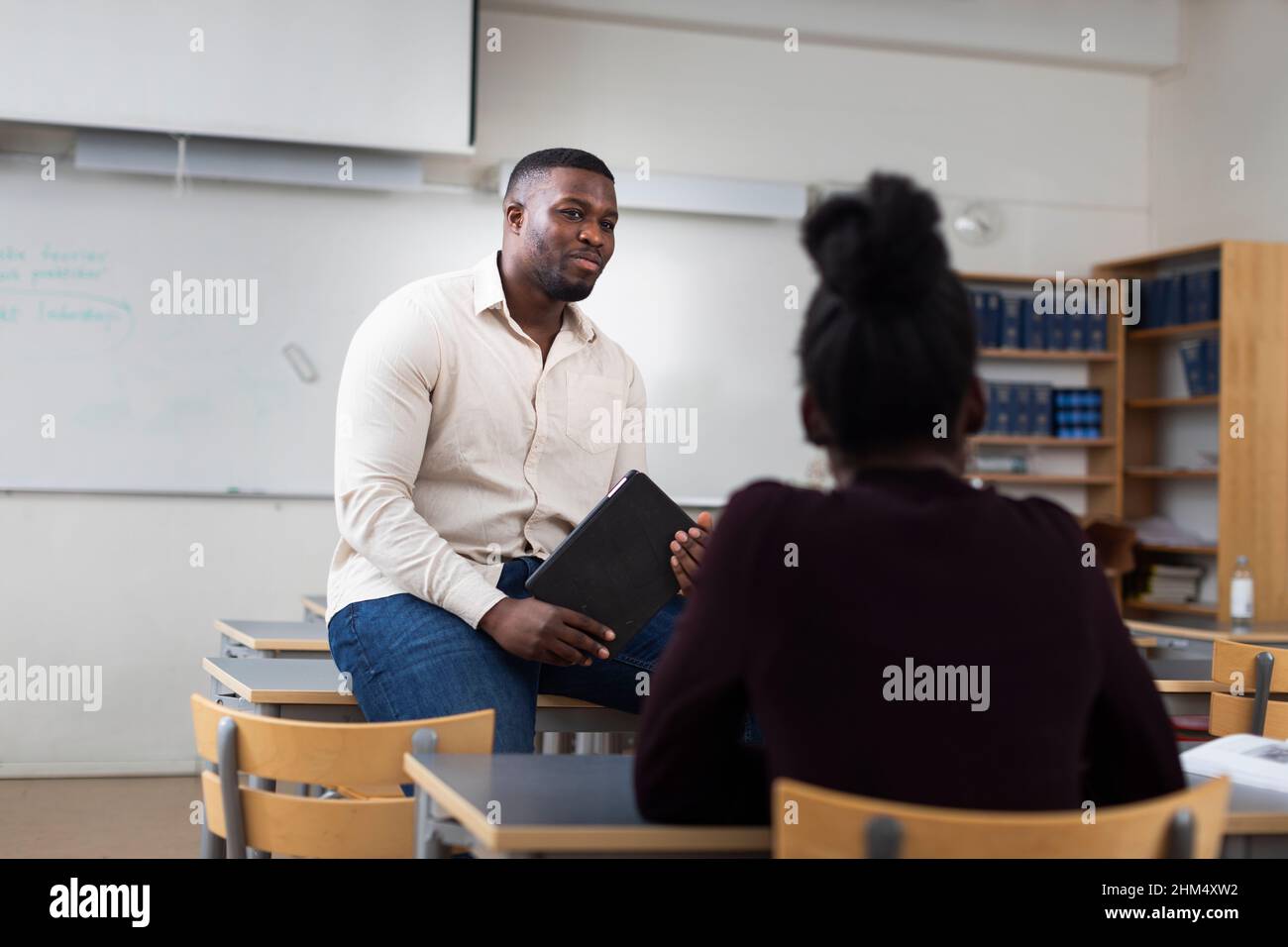 Teacher in classroom Stock Photo - Alamy