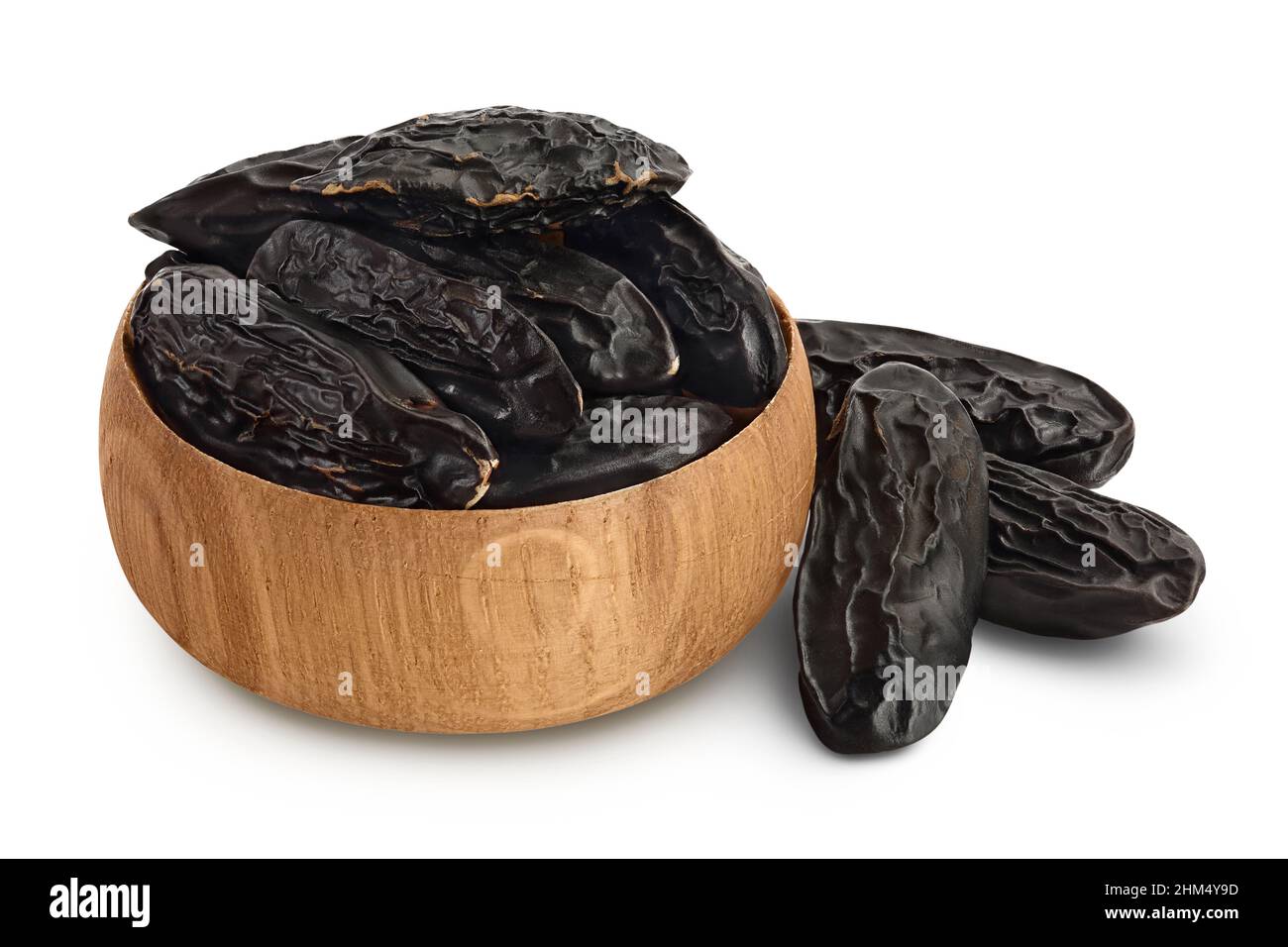Tonka bean in wooden bowl isolated on white background with clipping ...
