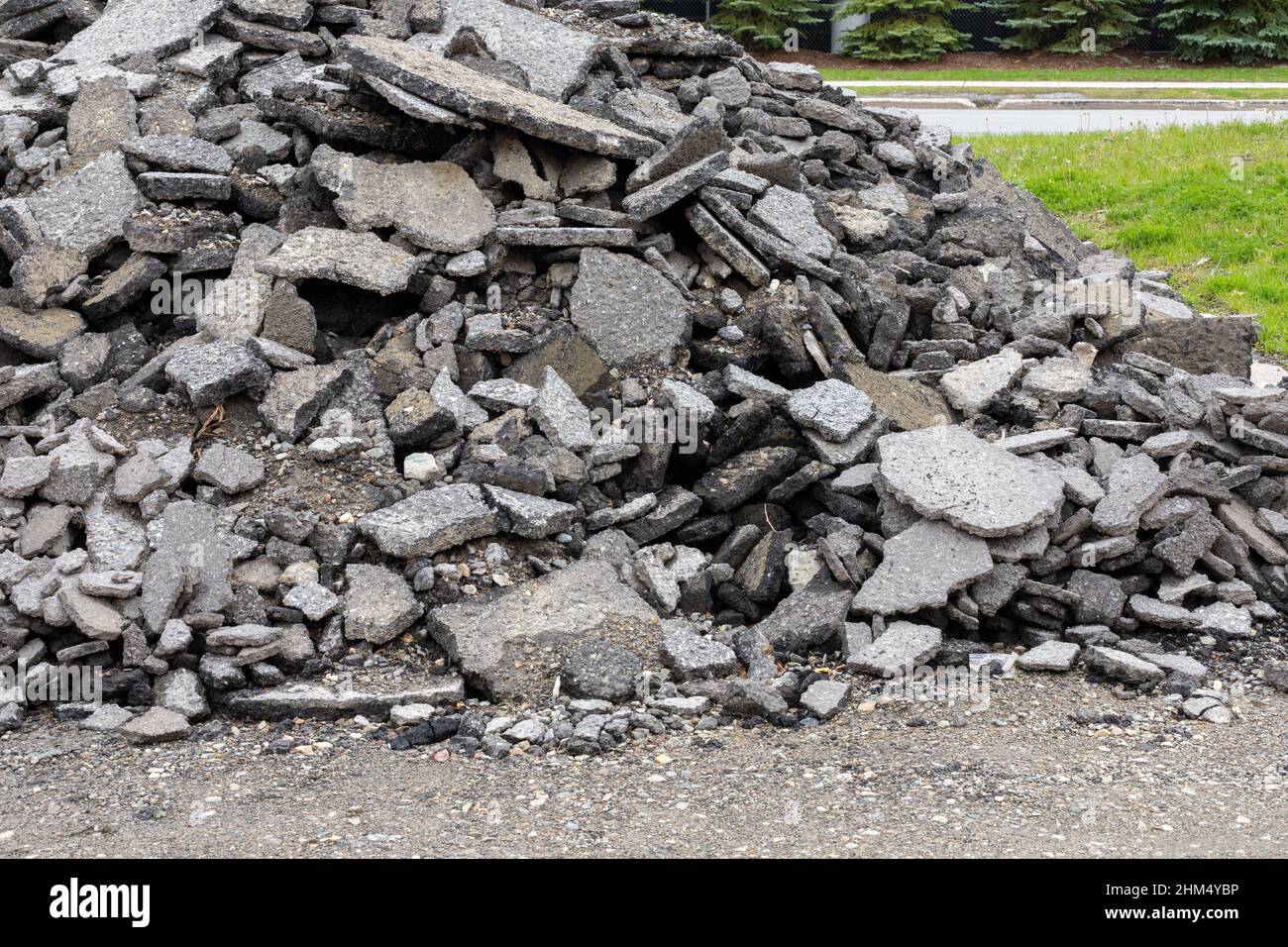 Pile of smashed concrete, old cracked asphalt rubble on the ground ...