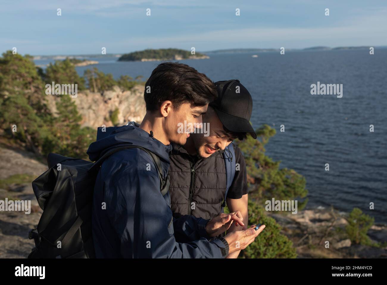 Smiling male friends standing hi-res stock photography and images - Alamy