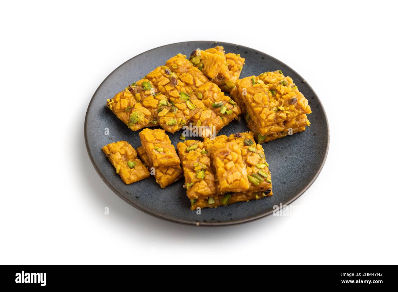 Traditional iranian dessert sohan on blue plate isolated on white ...