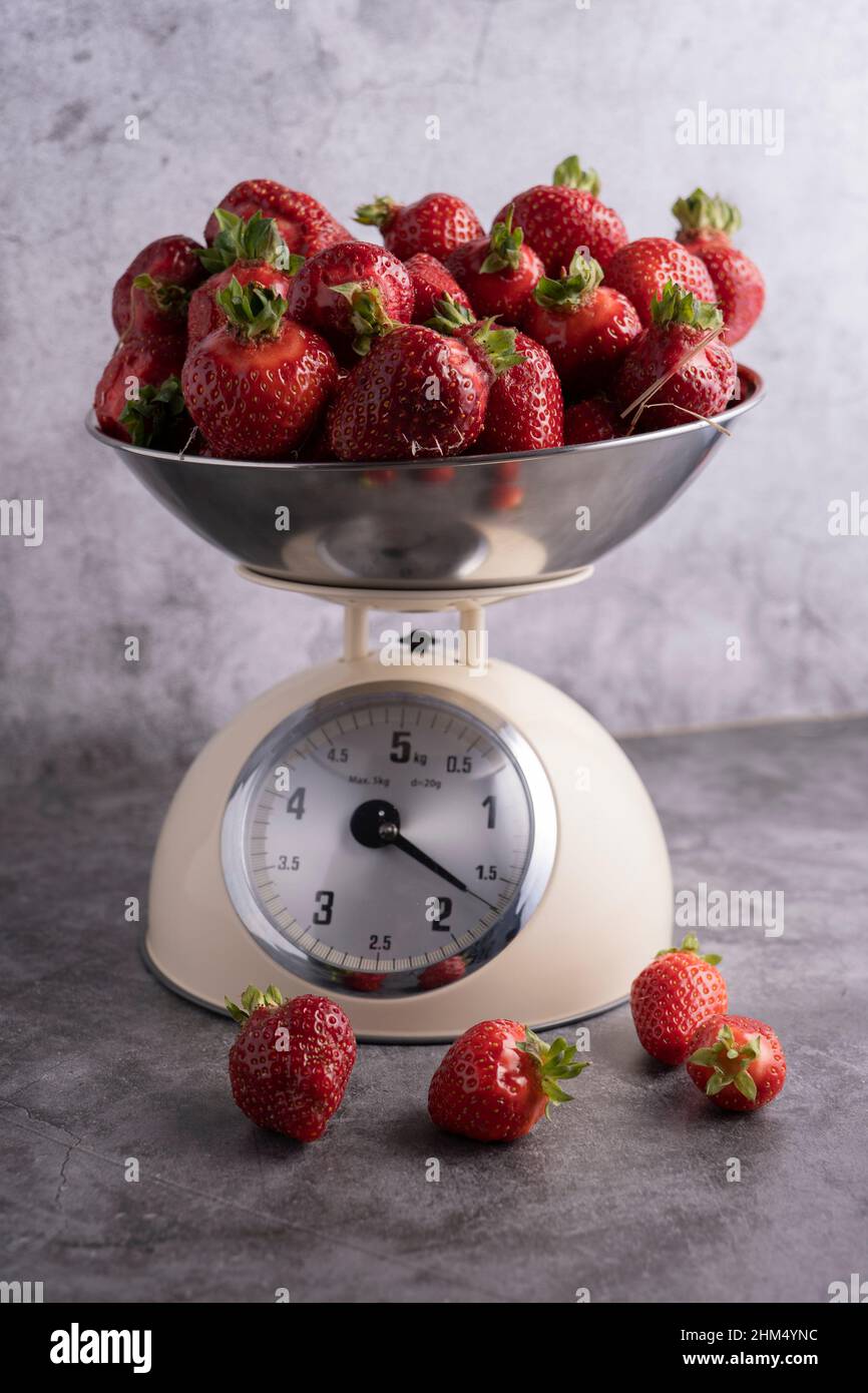 fresh, juicy strawberries are weighed in a scale pan Stock Photo - Alamy