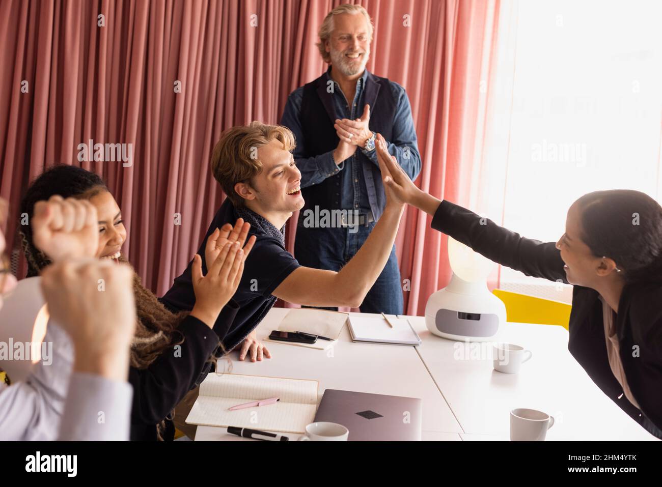 Business people high fiving during meeting Stock Photo - Alamy