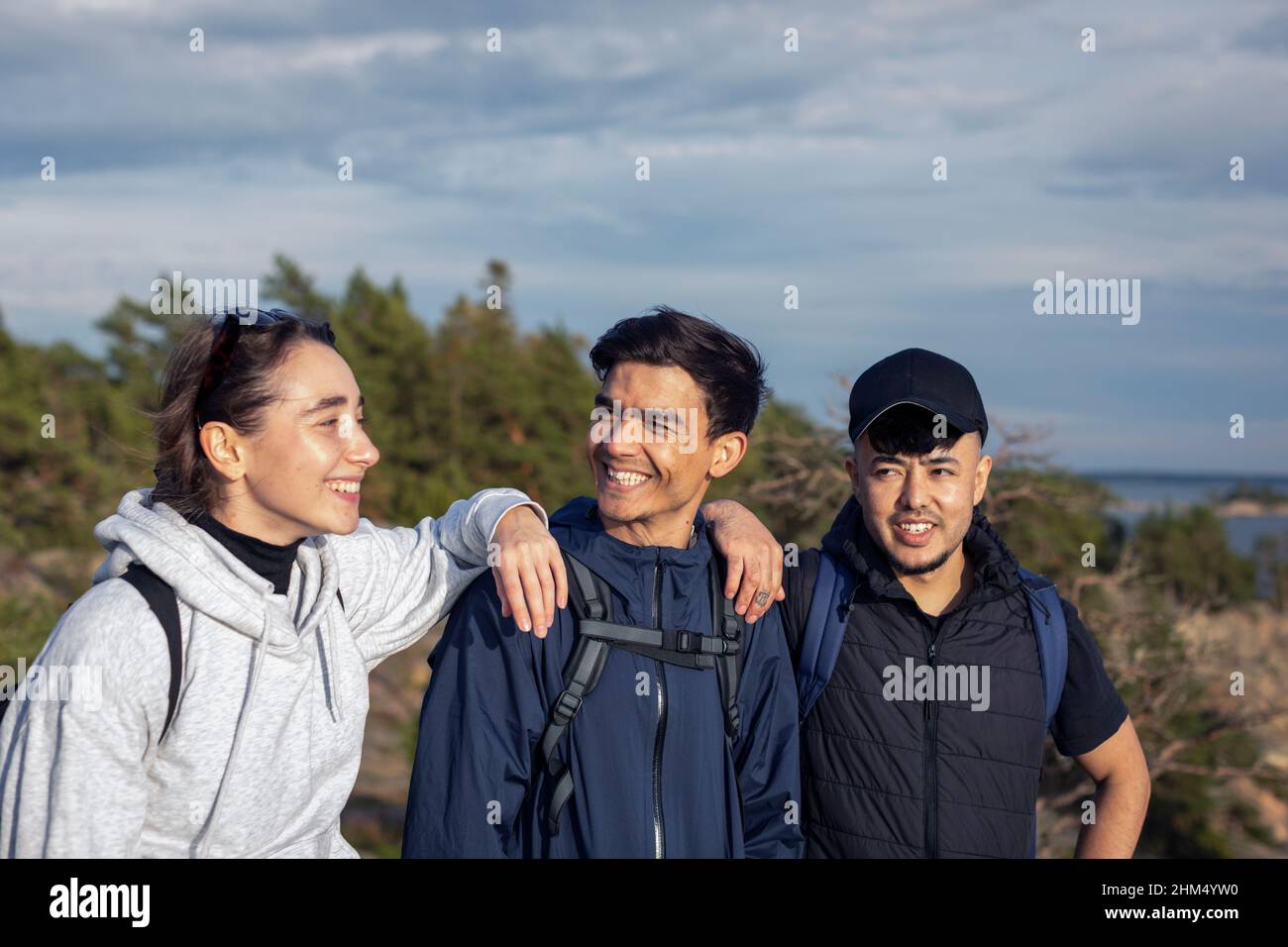 Happy friends standing together Stock Photo - Alamy
