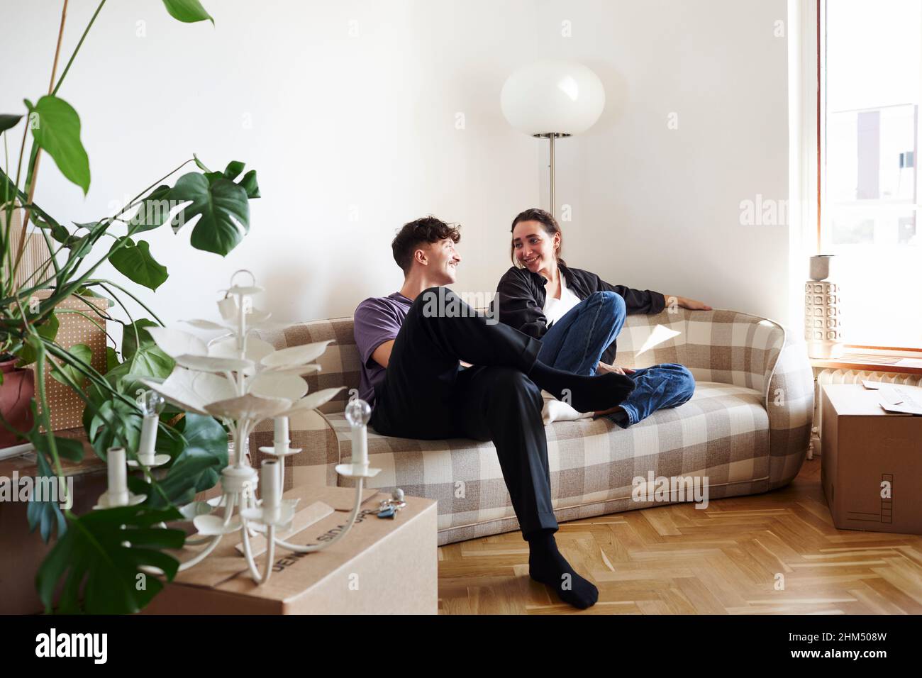 Two people sitting sofa hi-res stock photography and images - Alamy
