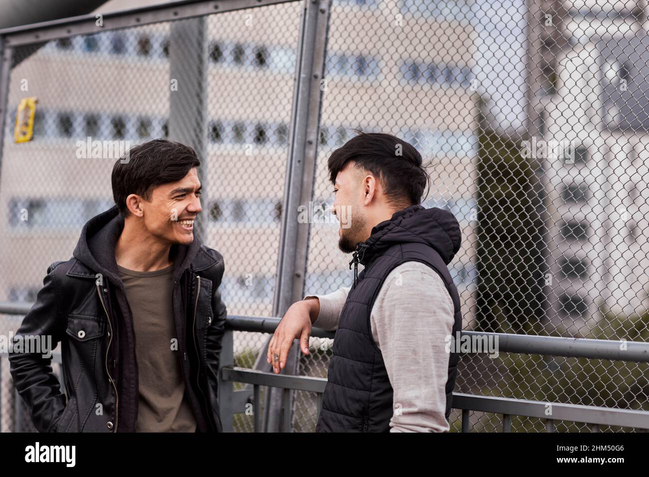 Male friends talking together Stock Photo - Alamy