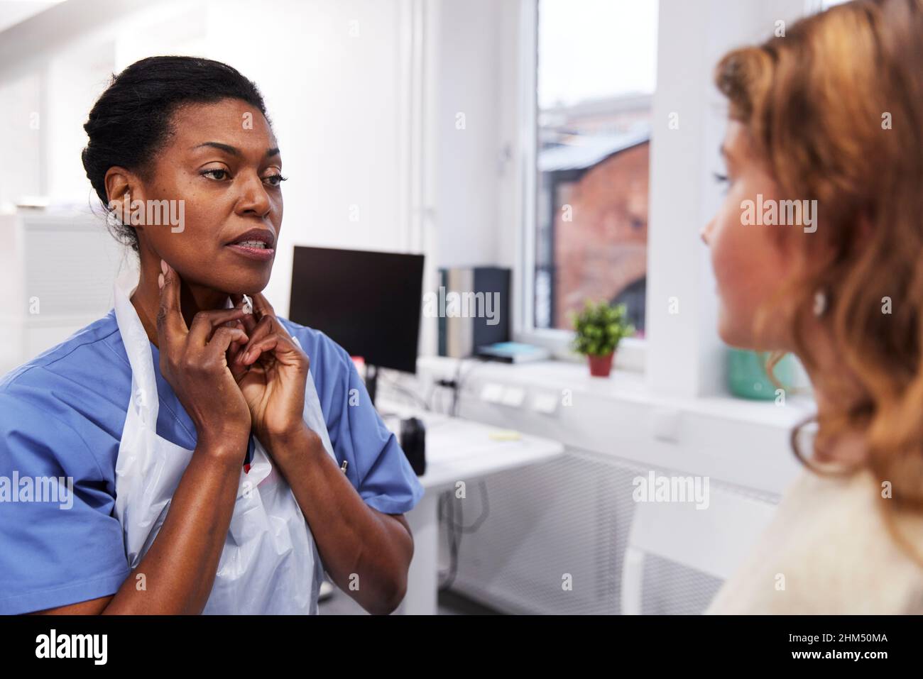 Female doctor talking to girl patient during appointment Stock Photo ...