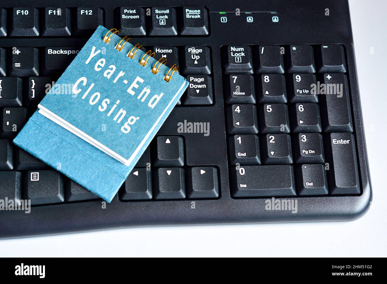 Text on calendar page on blue keyboard - Year end closing. Business and ...