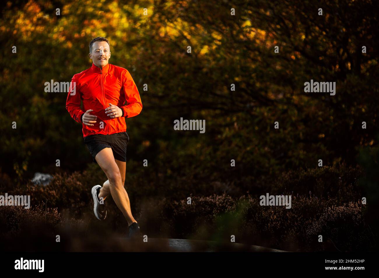 Smiling man jogging Stock Photo - Alamy