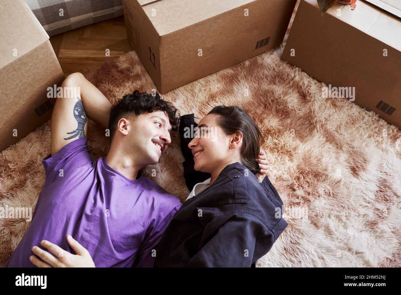Young couple lying down together Stock Photo - Alamy