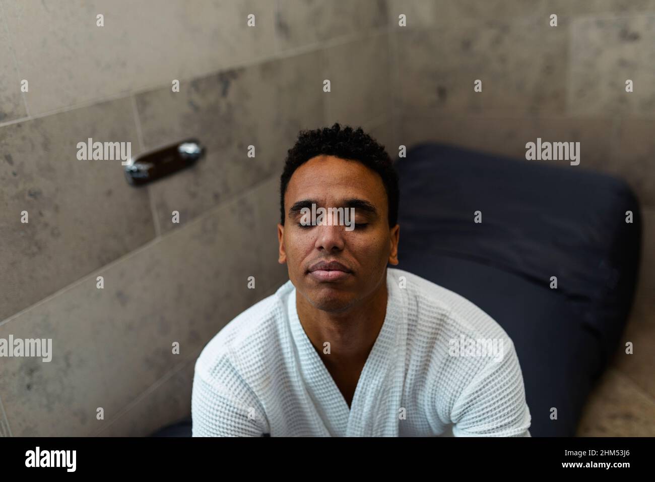 Man sitting with eyes shut Stock Photo - Alamy