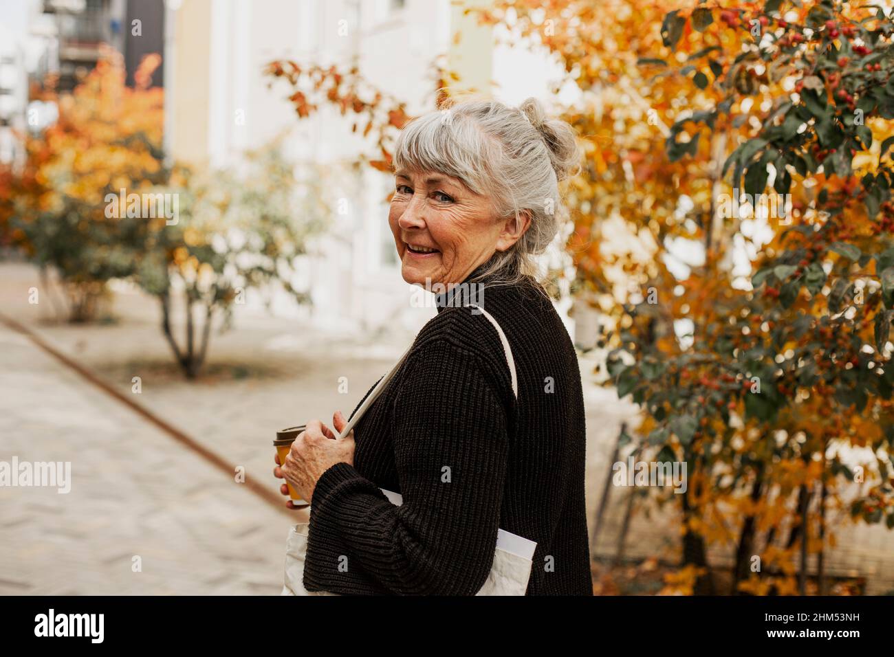 Senior woman walking and smiling Stock Photo - Alamy