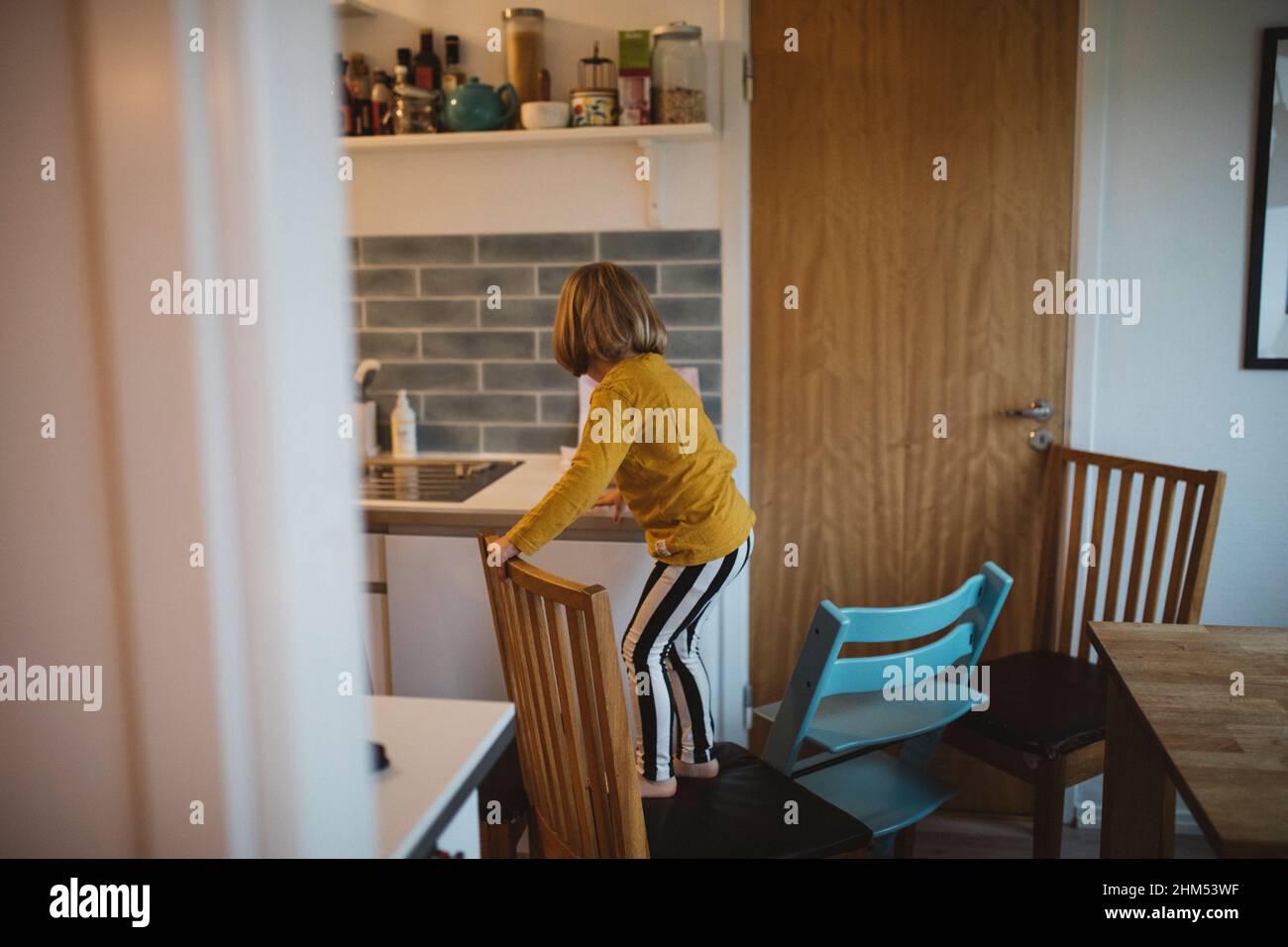 Standing on chair hi-res stock photography and images - Alamy