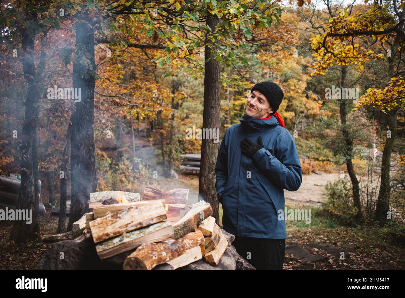 Man making campfire in forest Stock Photo - Alamy