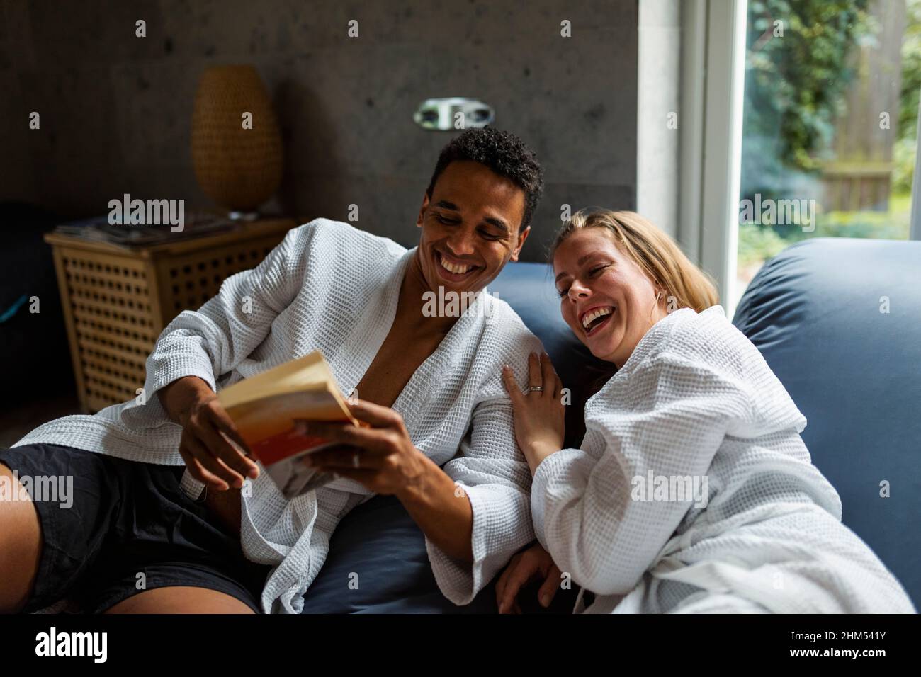 Couple relaxing together in living room Stock Photo - Alamy