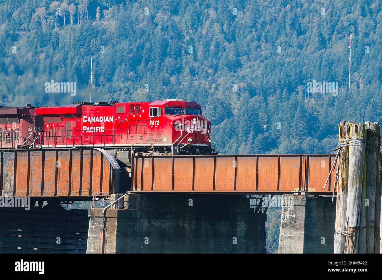 Canadian Pacific train locomotive #8812 crossing a bridge in Kilby, British Columbia, Canada ...