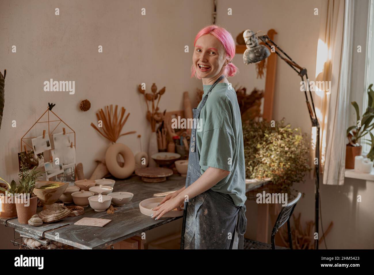 Cheerful woman standing plate clay hi-res stock photography and images ...