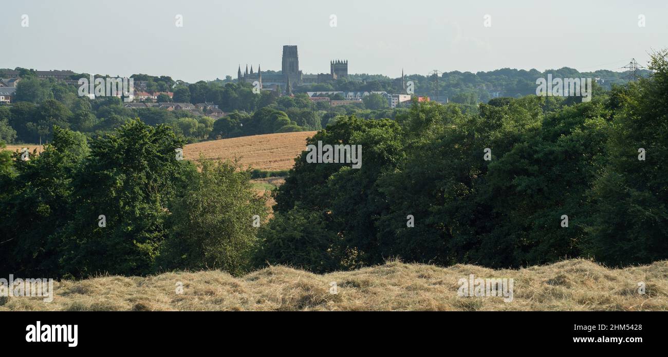 View of Durham Cathedral across open fields ready for harvesting from ...