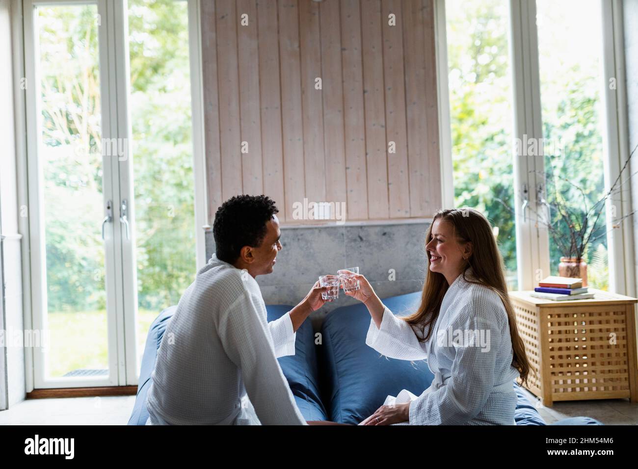 Couple relaxing together in living room Stock Photo - Alamy