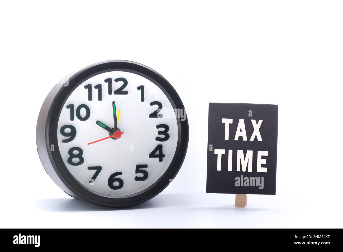 Tax time on black note and alarm clork on white background. To pay tax ...
