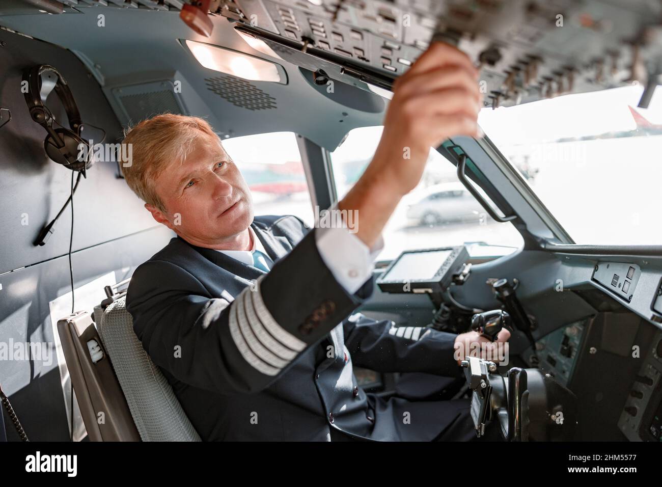 Aircraft pilot checking overhead panel before the flight Stock Photo ...