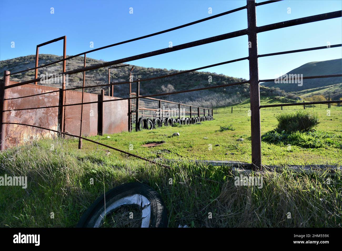 Cattle fencing on ranch made from Oil pumping pipe and old worn tires ...