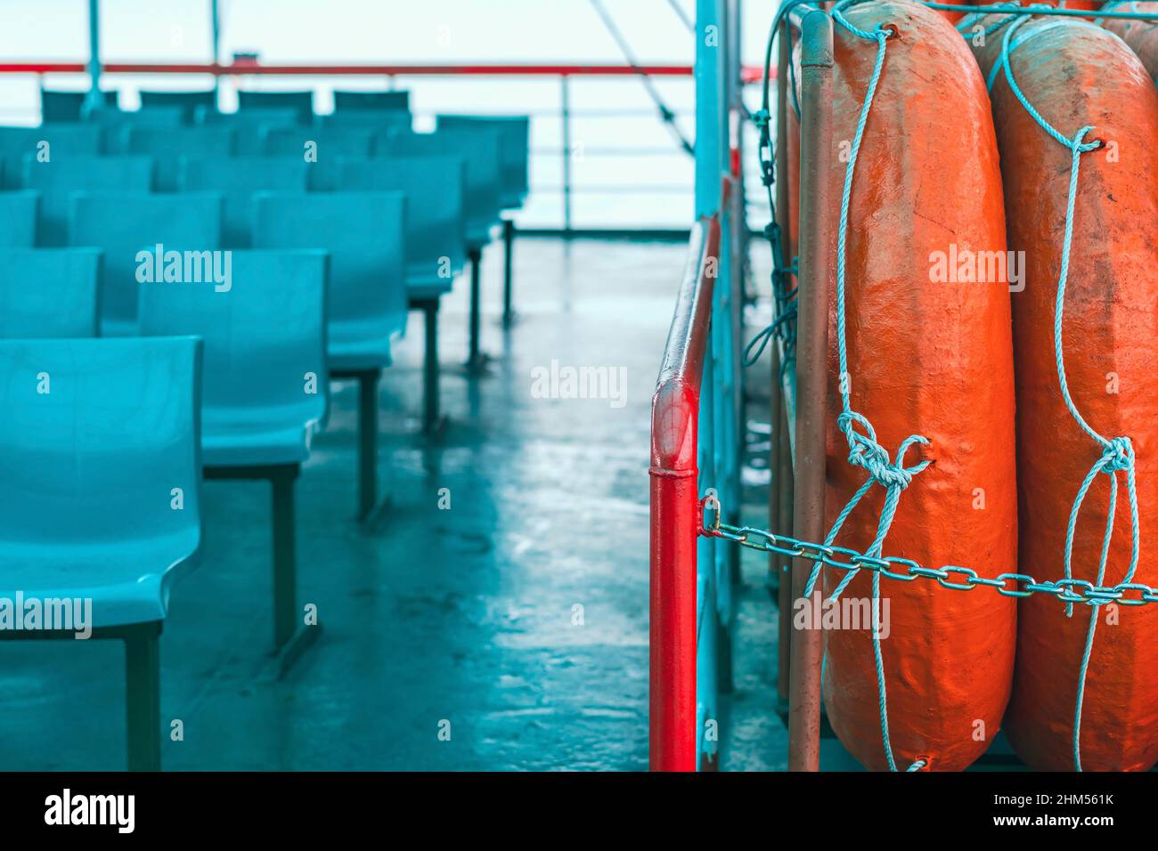 Orange inflatable lifeboats on ferry deck for emergencies and maritime ...