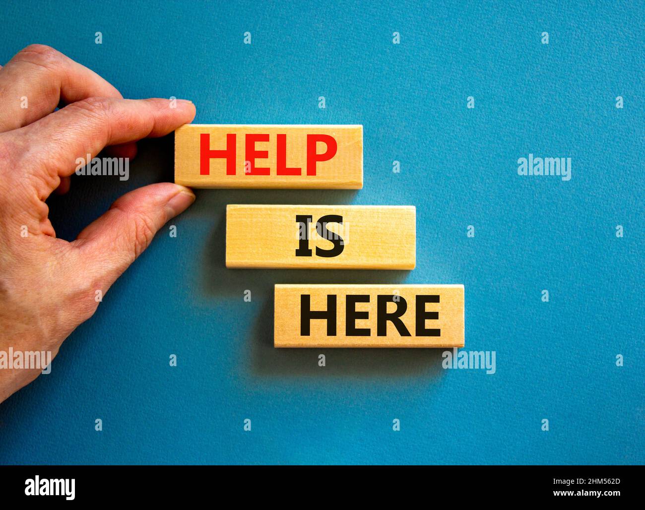 Help is here and support symbol. Concept words Help is here on wooden ...