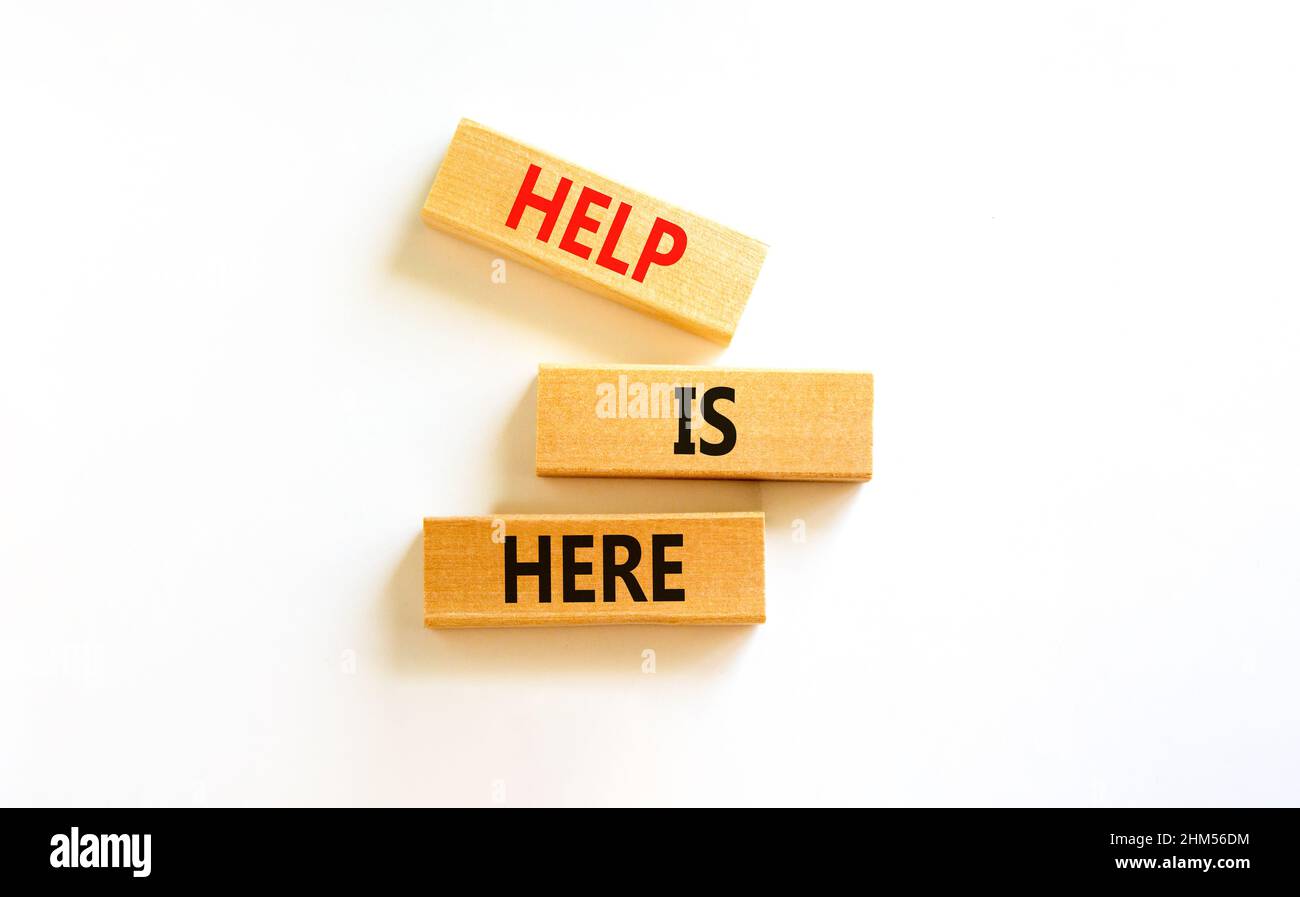 Help is here and support symbol. Concept words Help is here on wooden ...
