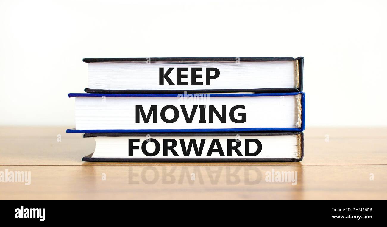 Keep moving forward symbol. Concept words Keep moving forward on books ...