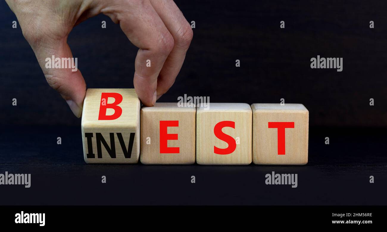 Best invest symbol. Businessman turns a wooden cube and changes the ...