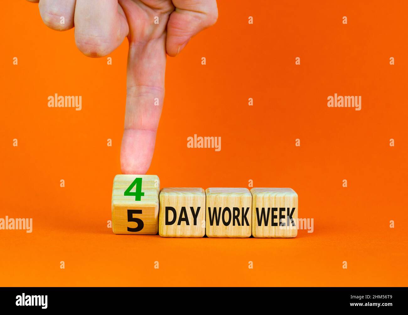 4 or 5 day work week symbol. Businessman turns cubes and changes words ...