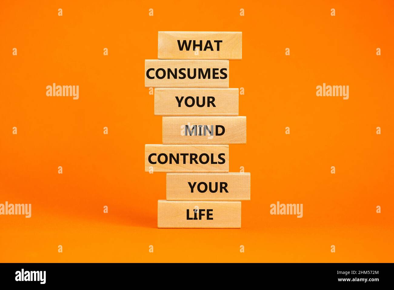 Motivational symbol. Wooden blocks with words What consumes your mind ...