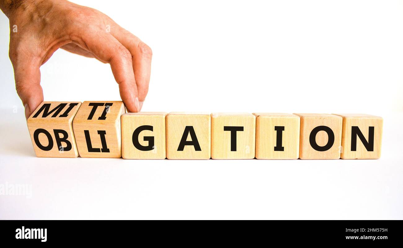 Obligation and mitigation symbol. Businessman turns wooden cubes ...