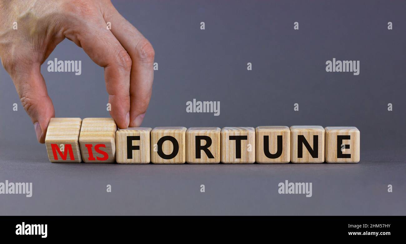Fortune or misfortune symbol. Businessman turns wooden cubes and ...