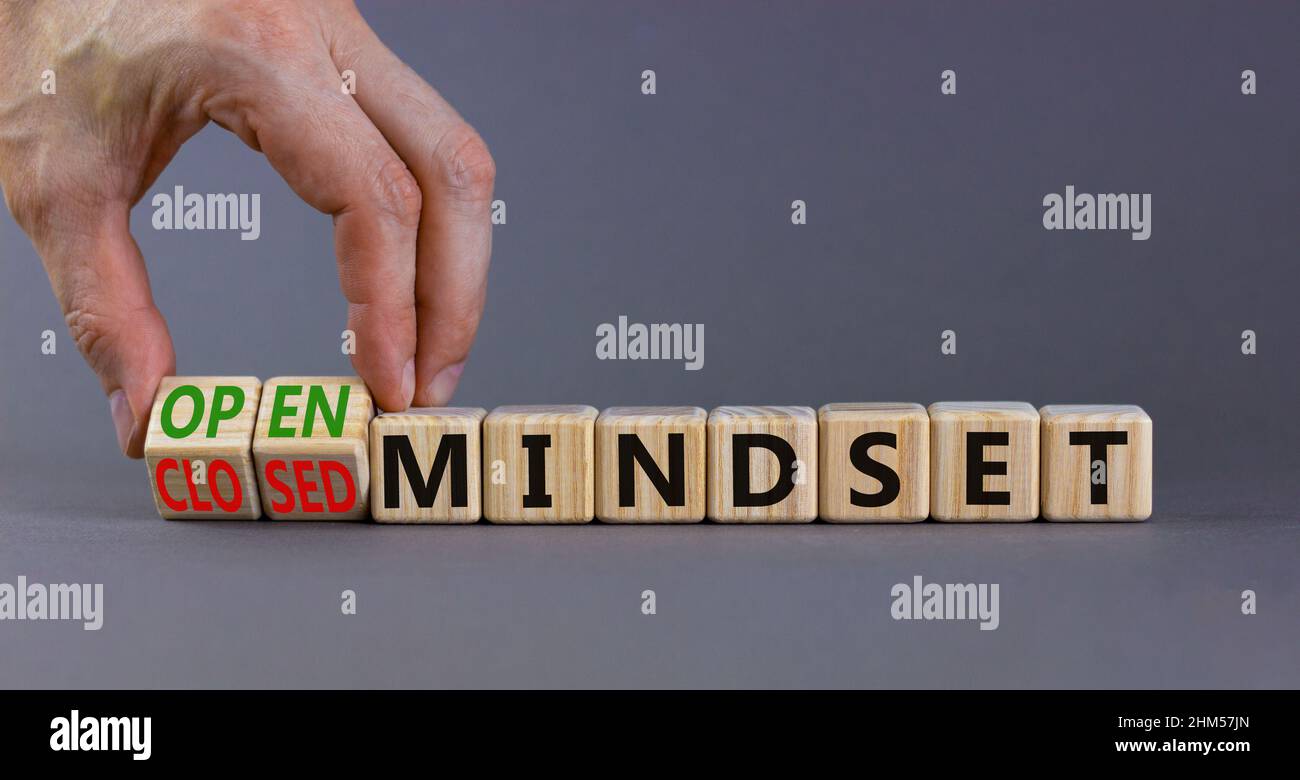 Open or closed mindset symbol. Businessman turns wooden cubes and ...