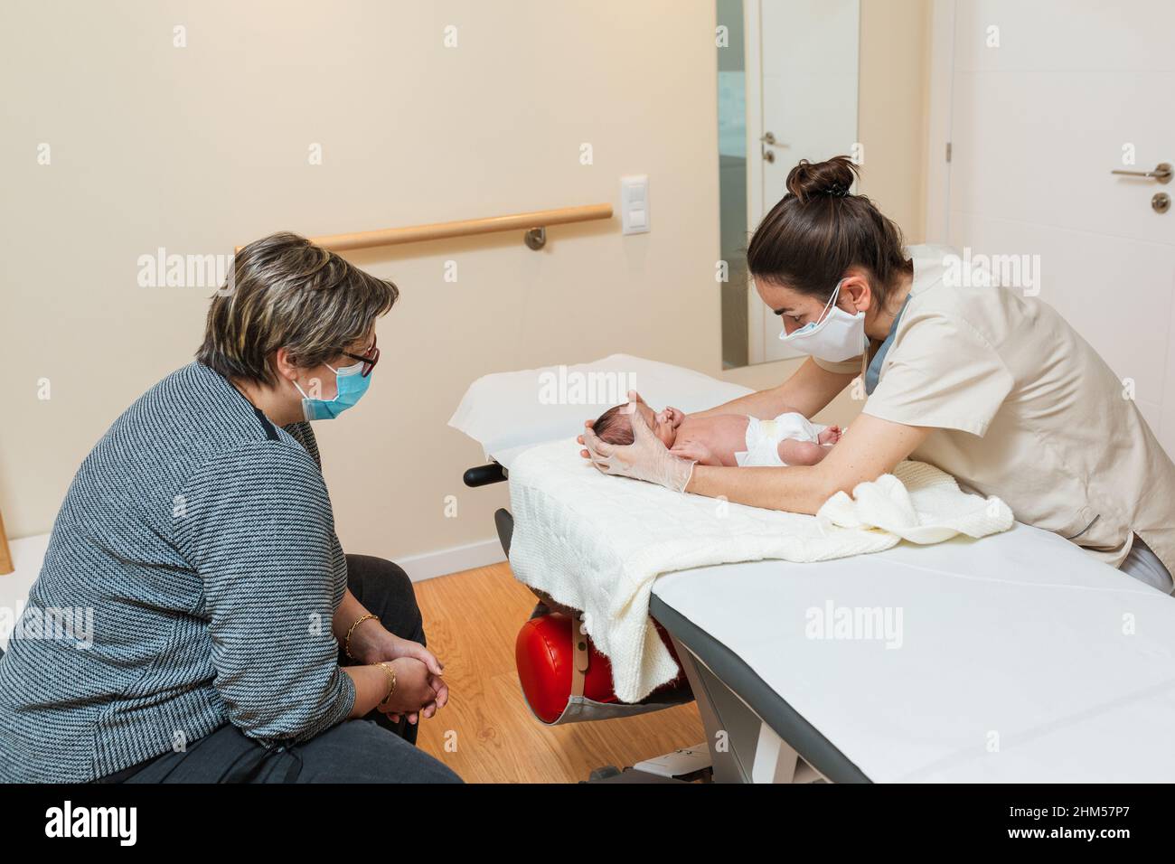 Professional physiotherapist doing an extensor tone relaxation on a ...